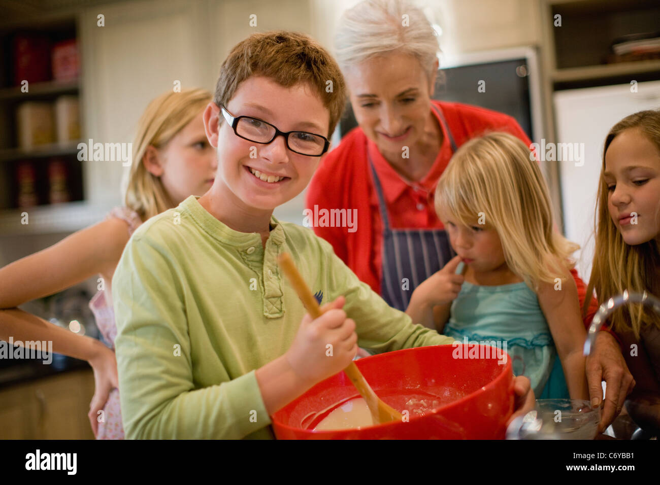 Family cooking together in kitchen Stock Photo - Alamy