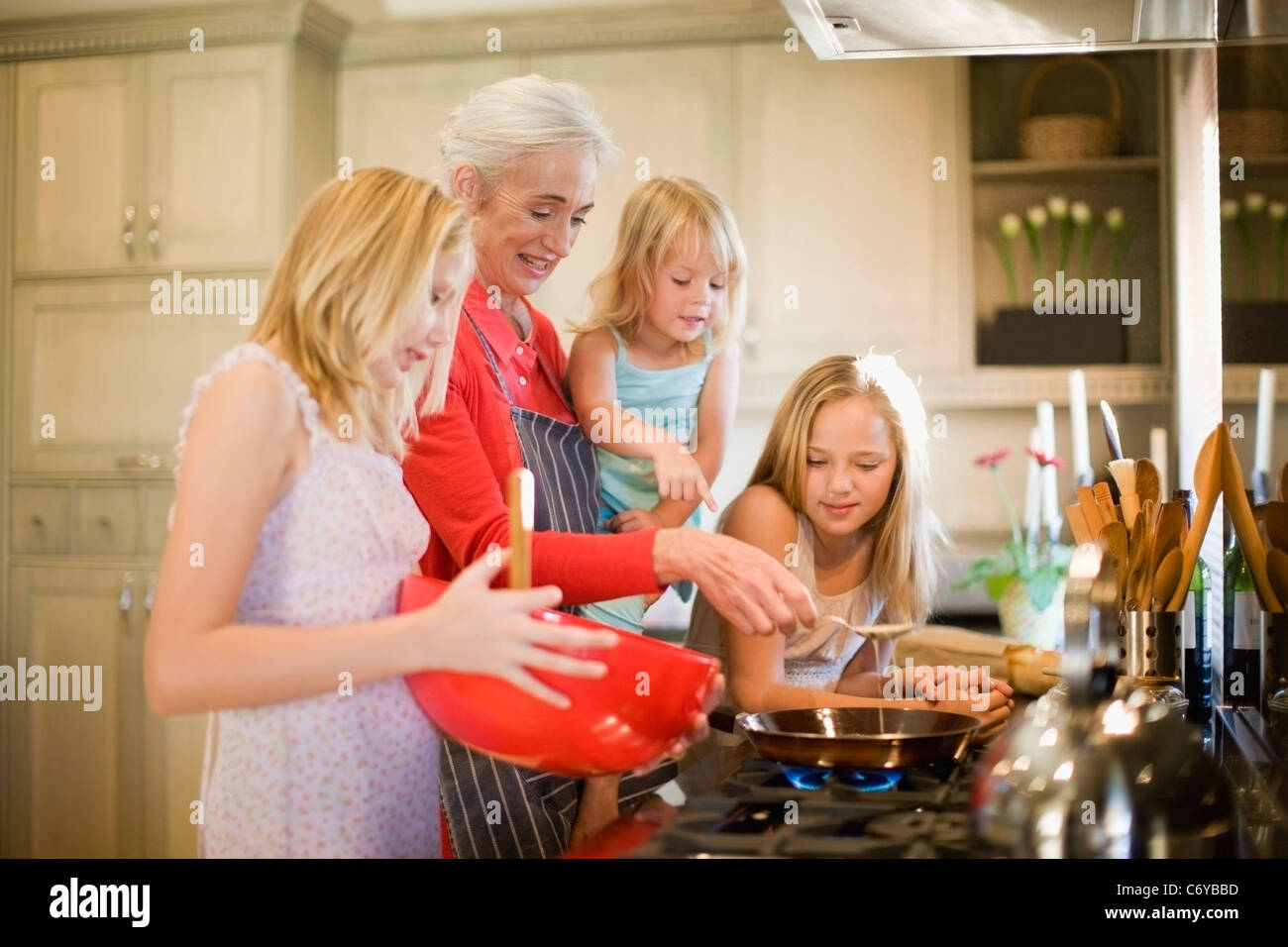 Family cooking together in kitchen Stock Photo - Alamy