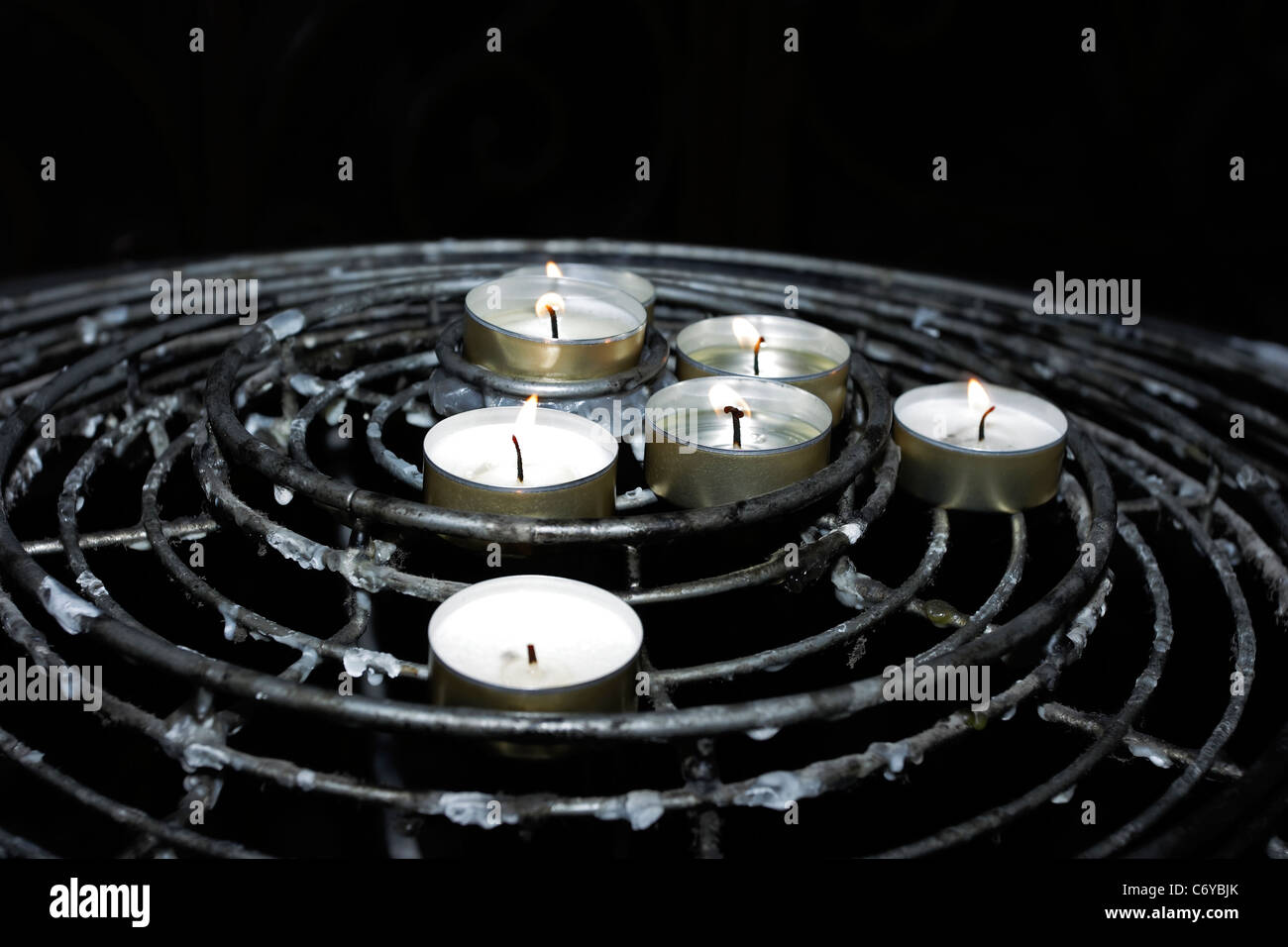 Offertory or Prayer Candles burning in remembrance of loved ones in a ...