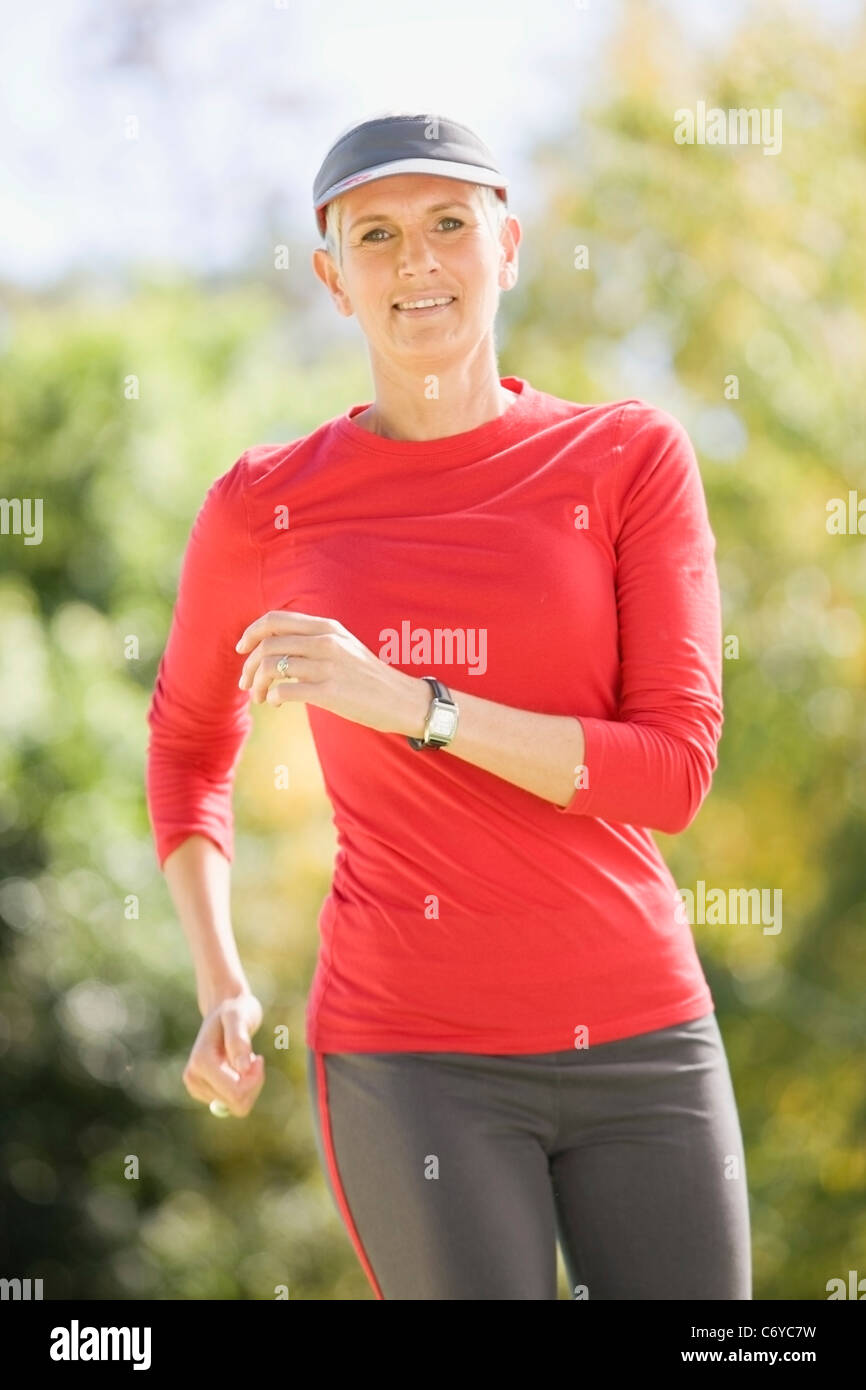 Smiling woman walking outdoors Stock Photo - Alamy