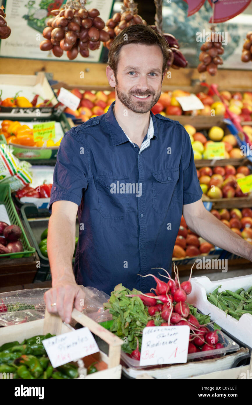 Man smiling in produce stand Stock Photo - Alamy