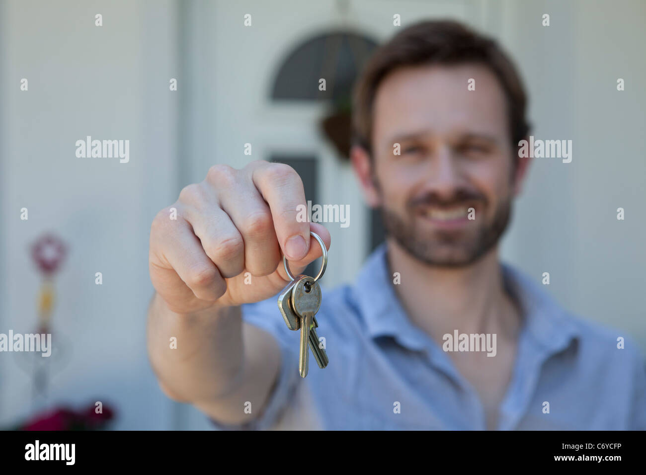 Man offering set of keys Stock Photo - Alamy
