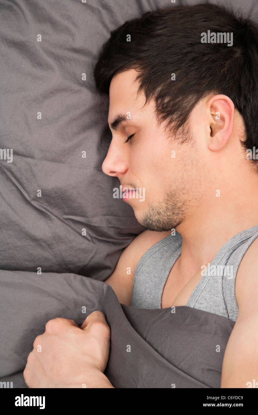 Man asleep in bed Stock Photo - Alamy