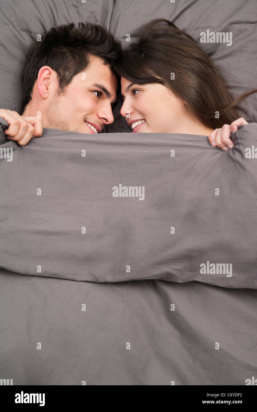 Couple laying in bed together Stock Photo - Alamy