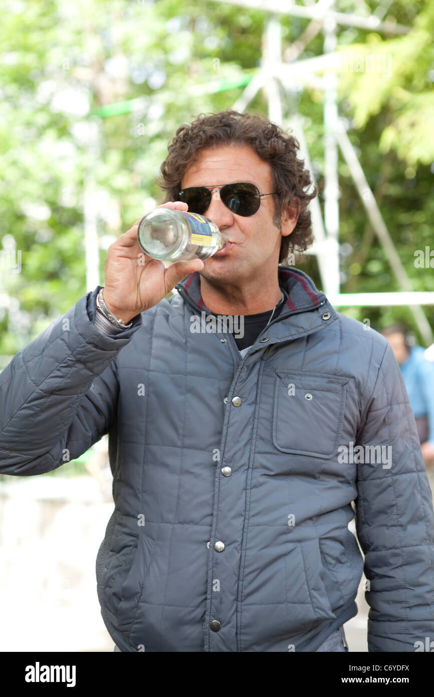 Man drinking water from a glass bottle Stock Photo - Alamy