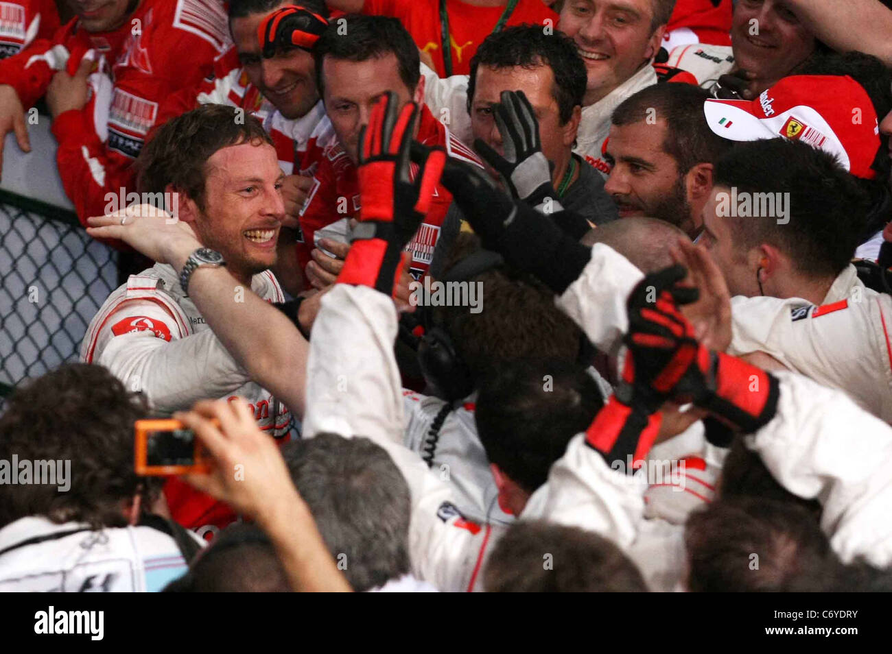 Jenson Button celebrates on the podium after winning Formula One's ...