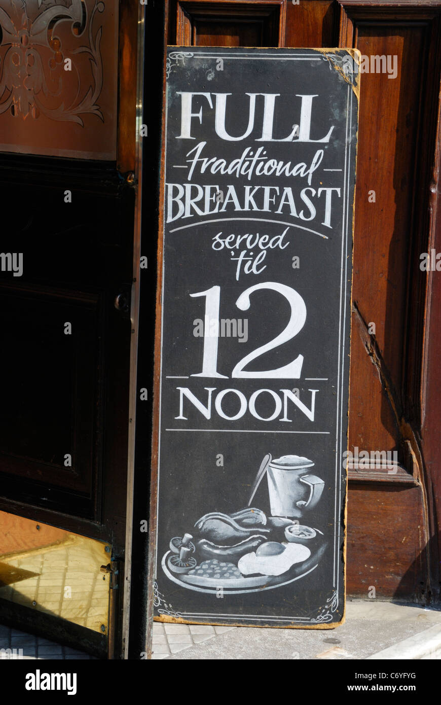 Blackboard sign outside a pub promoting a 'Full Traditional Breakfast ...
