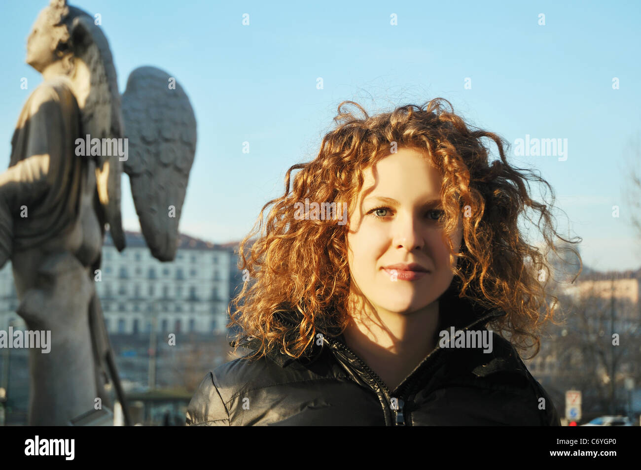Woman standing on city street Stock Photo - Alamy