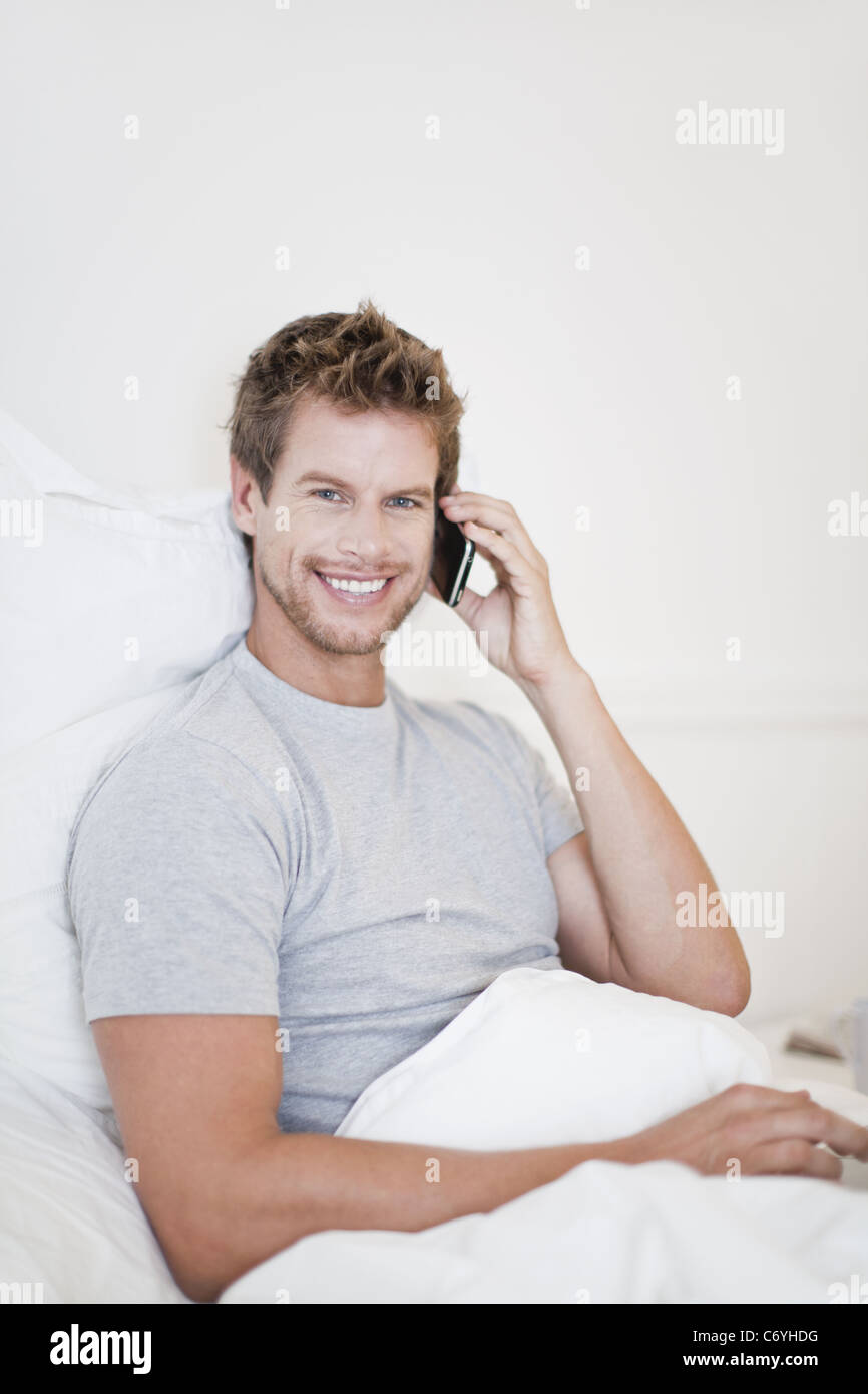Guy in bed with phone looking at camera hi-res stock photography and ...
