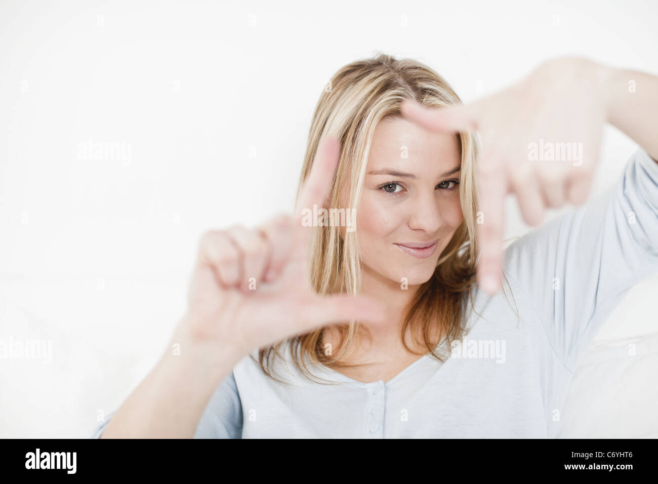 Woman making square with her fingers Stock Photo - Alamy