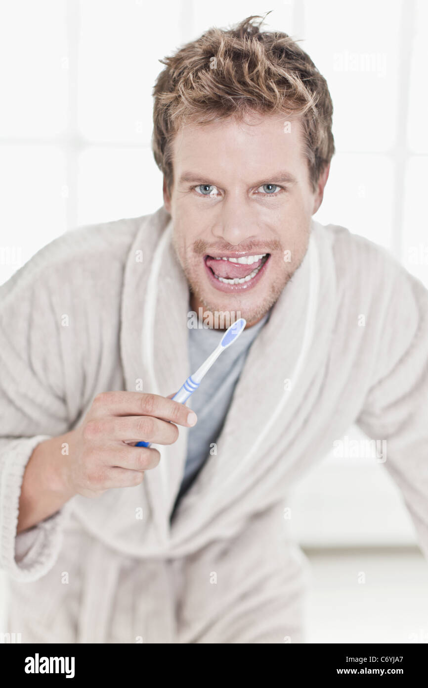Man brushing his teeth in bathroom Stock Photo - Alamy