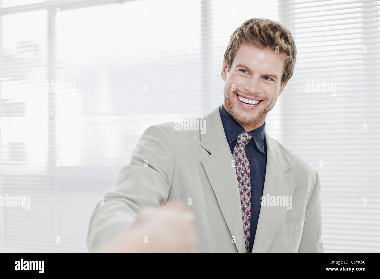 Businessman smiling in office Stock Photo - Alamy