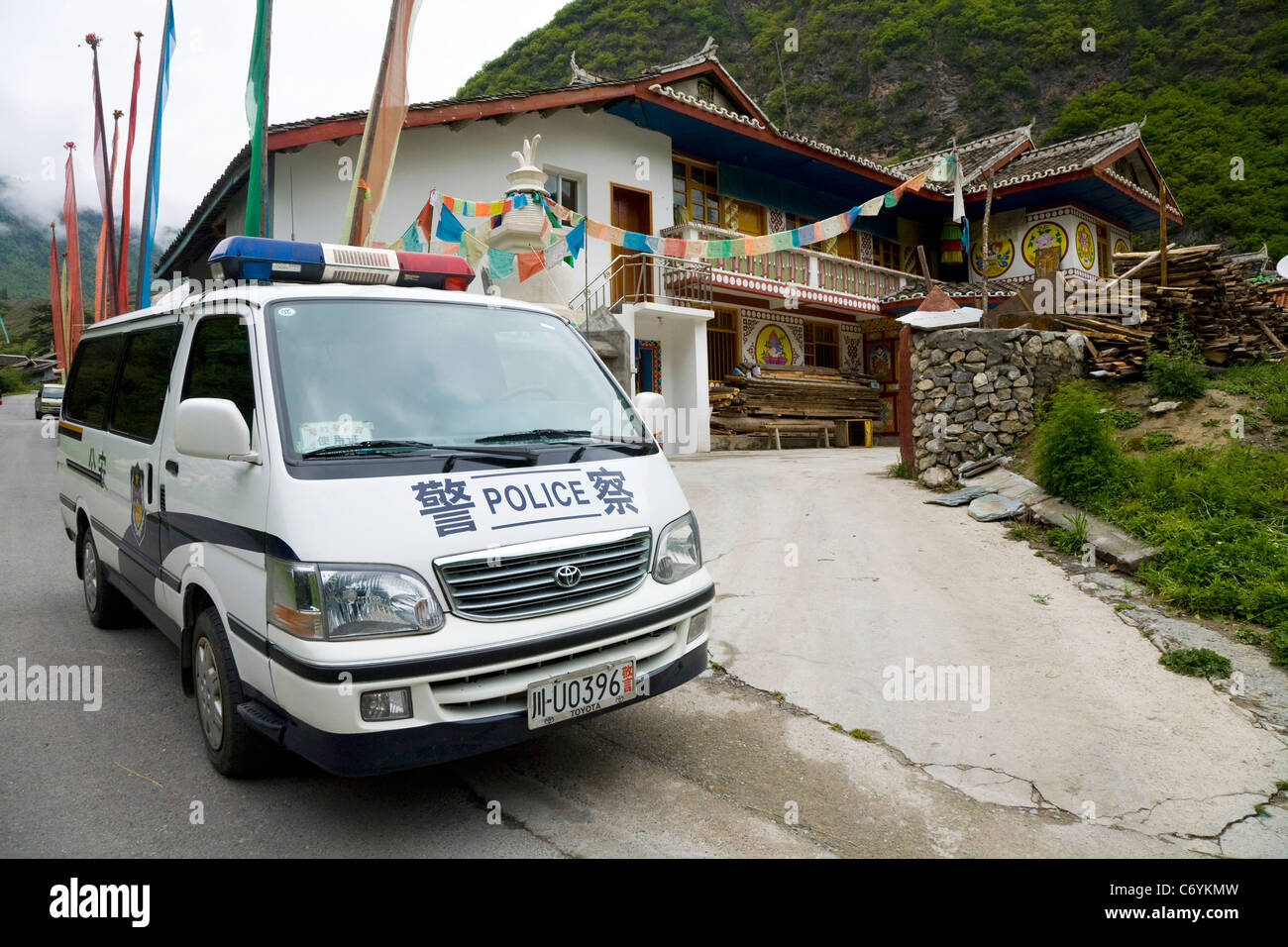 Police car / vehicle parked outside a tibetan style house. Jiuzhaigou ...