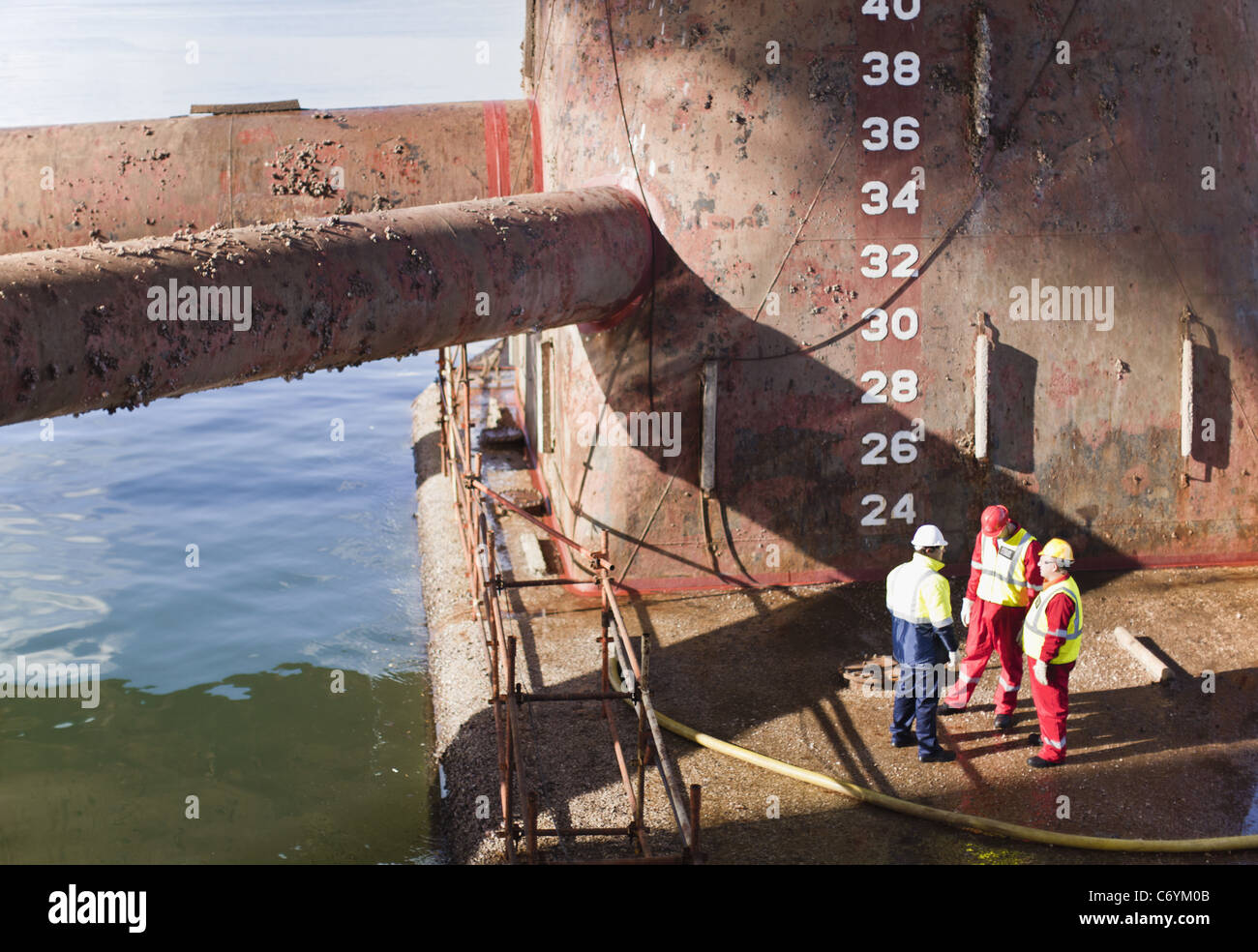 Workers standing on oil rig Stock Photo - Alamy