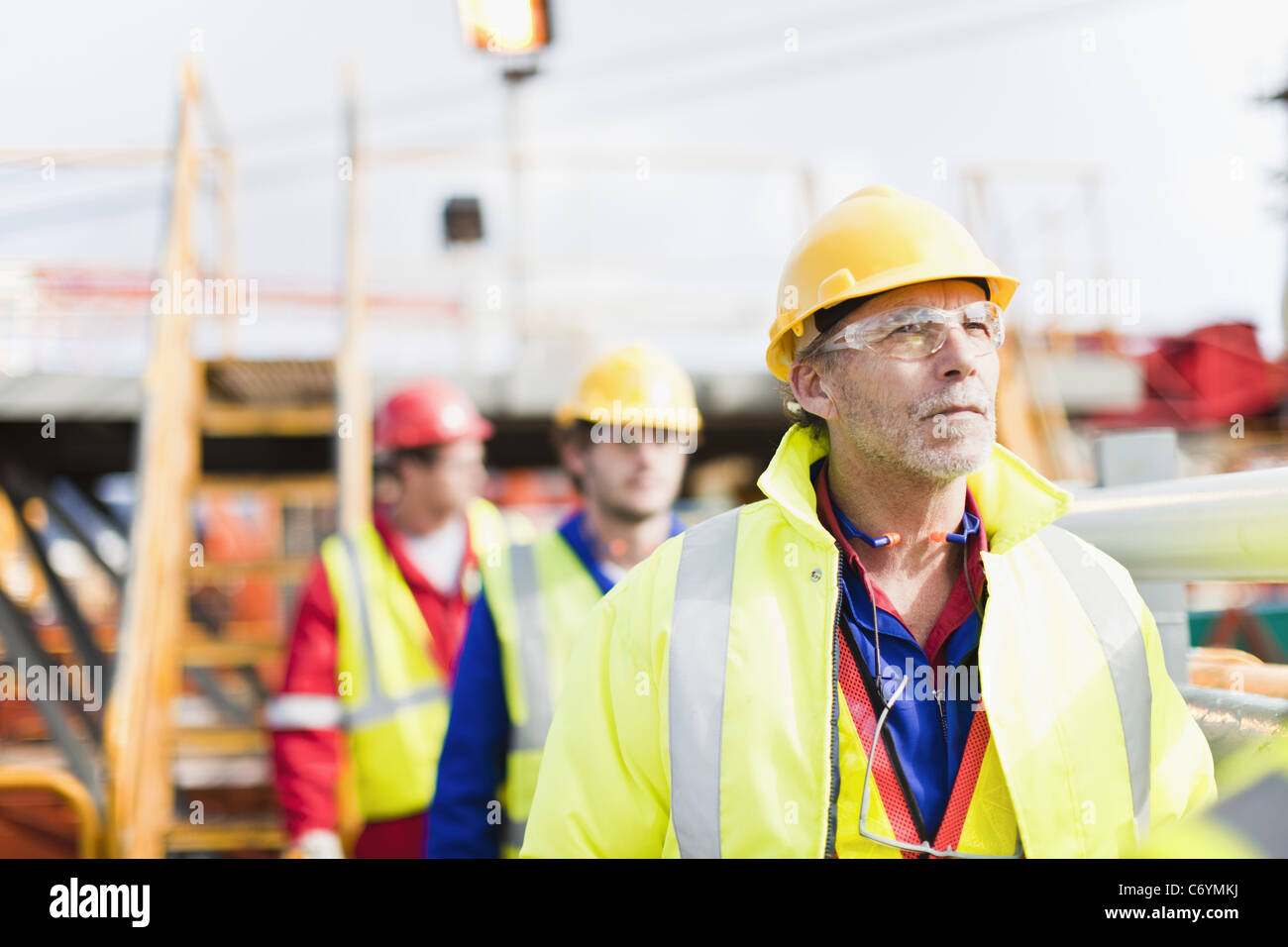 Workers walking on oil rig Stock Photo - Alamy