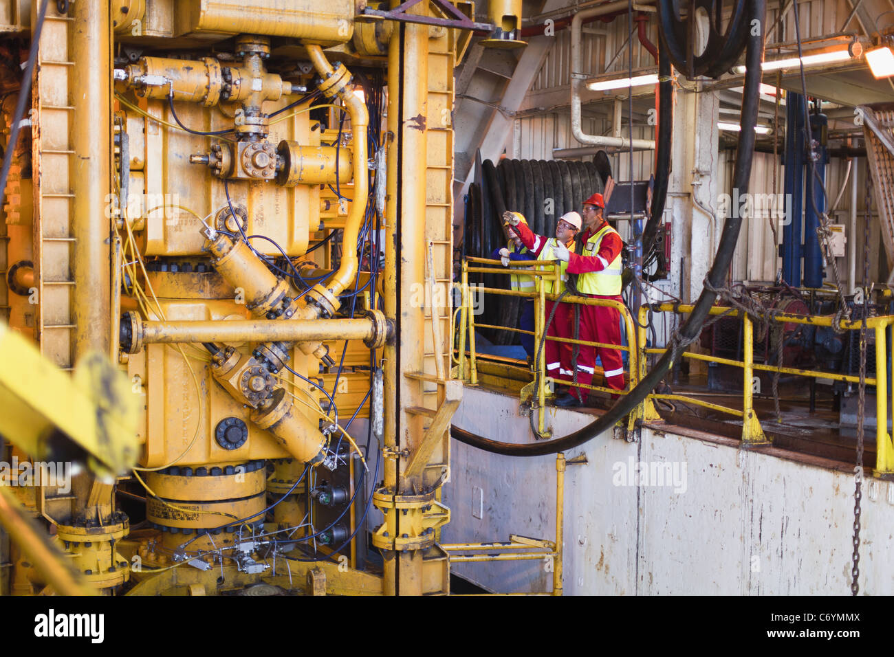 Workers on oil rig Stock Photo - Alamy