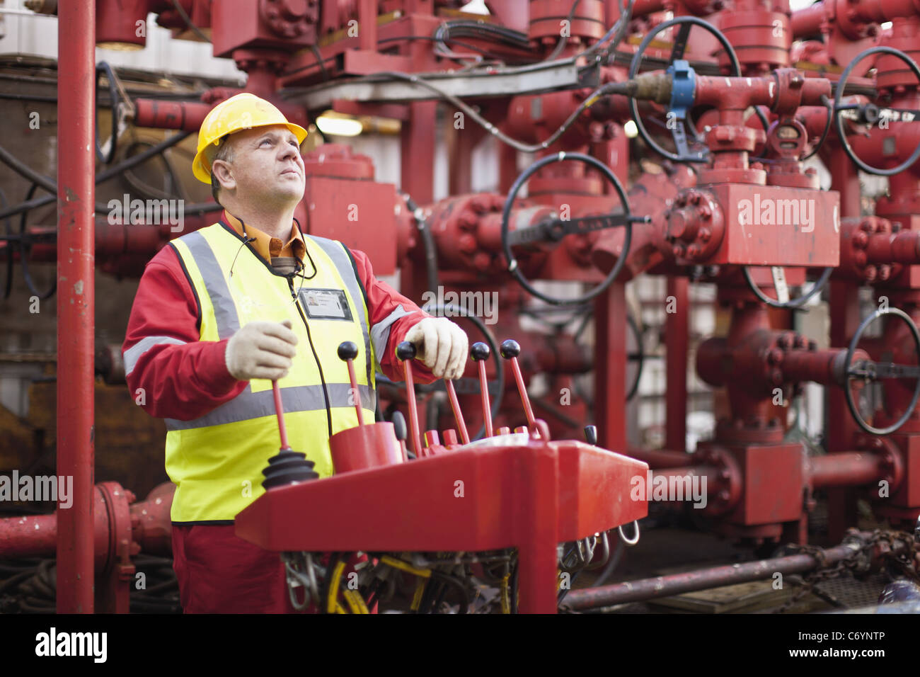 Worker sitting in chair on oil rig Stock Photo - Alamy