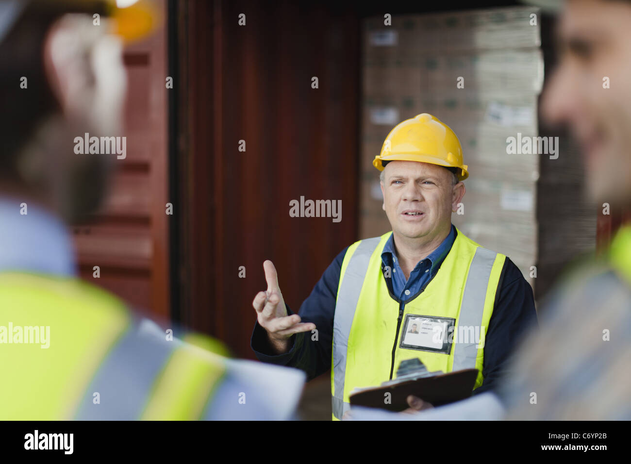 Workers talking in shipping yard Stock Photo - Alamy