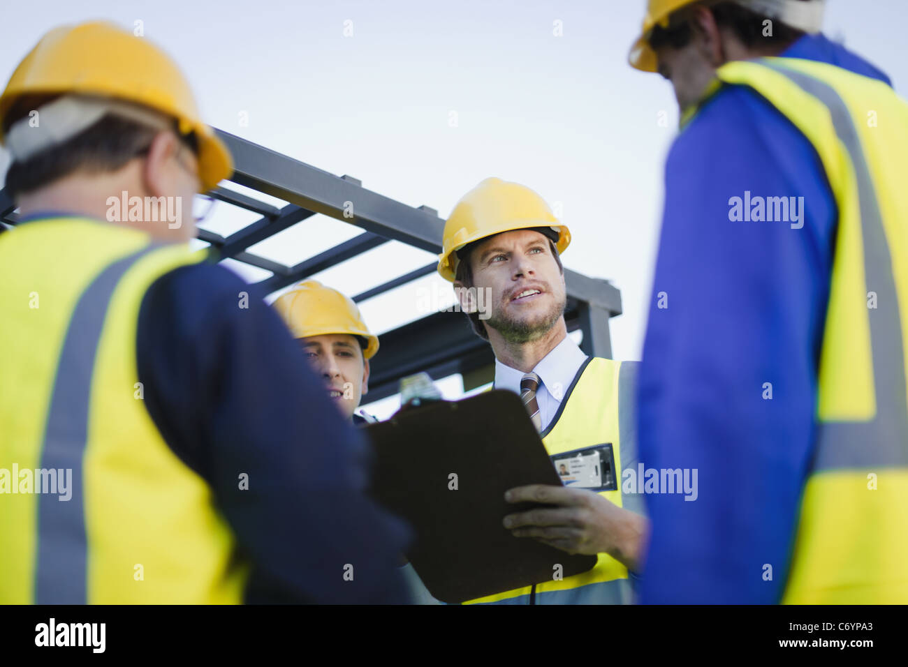 Workers talking at construction site Stock Photo - Alamy