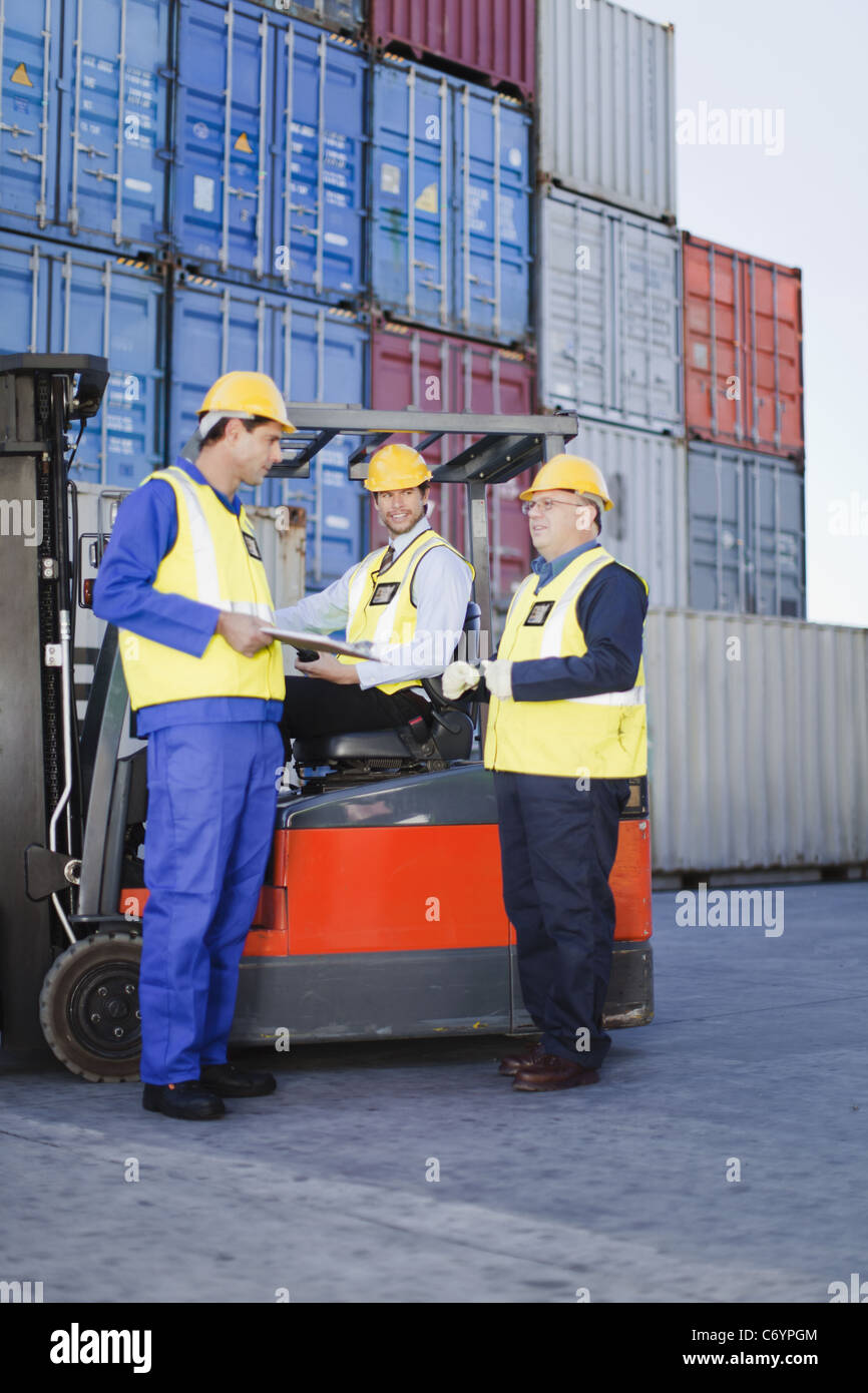 Workers talking in shipping yard Stock Photo - Alamy