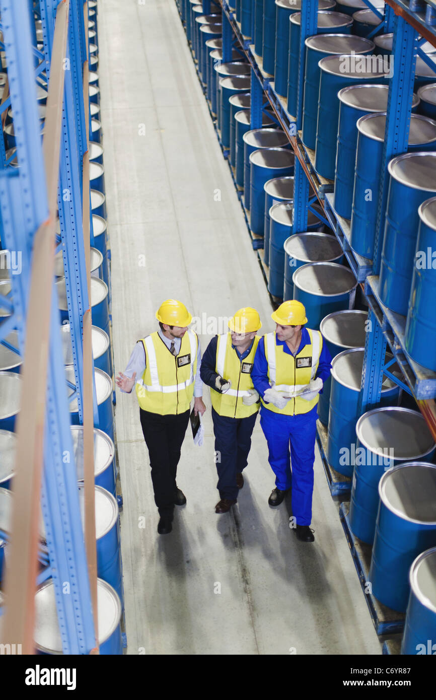 Workers talking in warehouse Stock Photo - Alamy