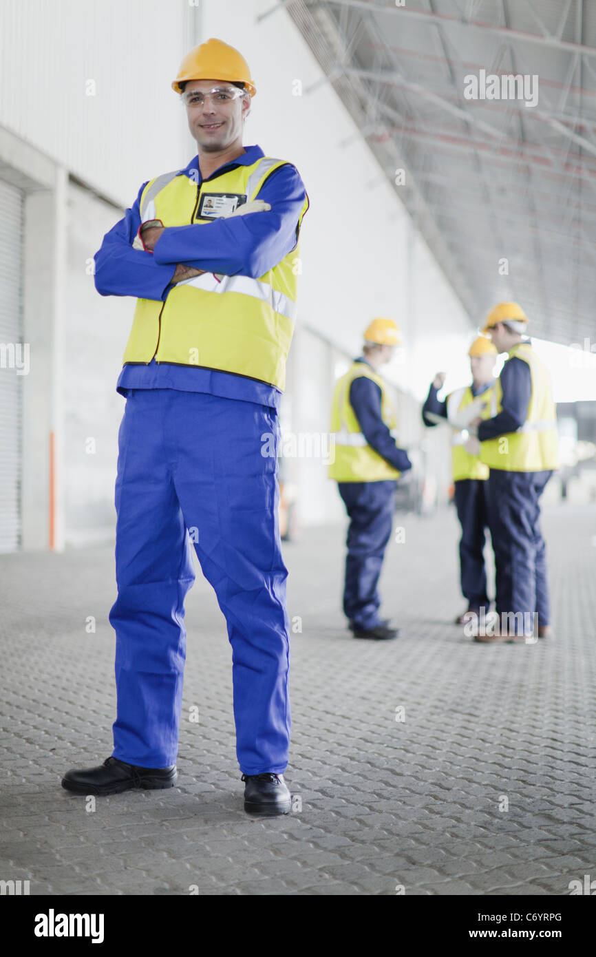 Worker standing in warehouse Stock Photo - Alamy