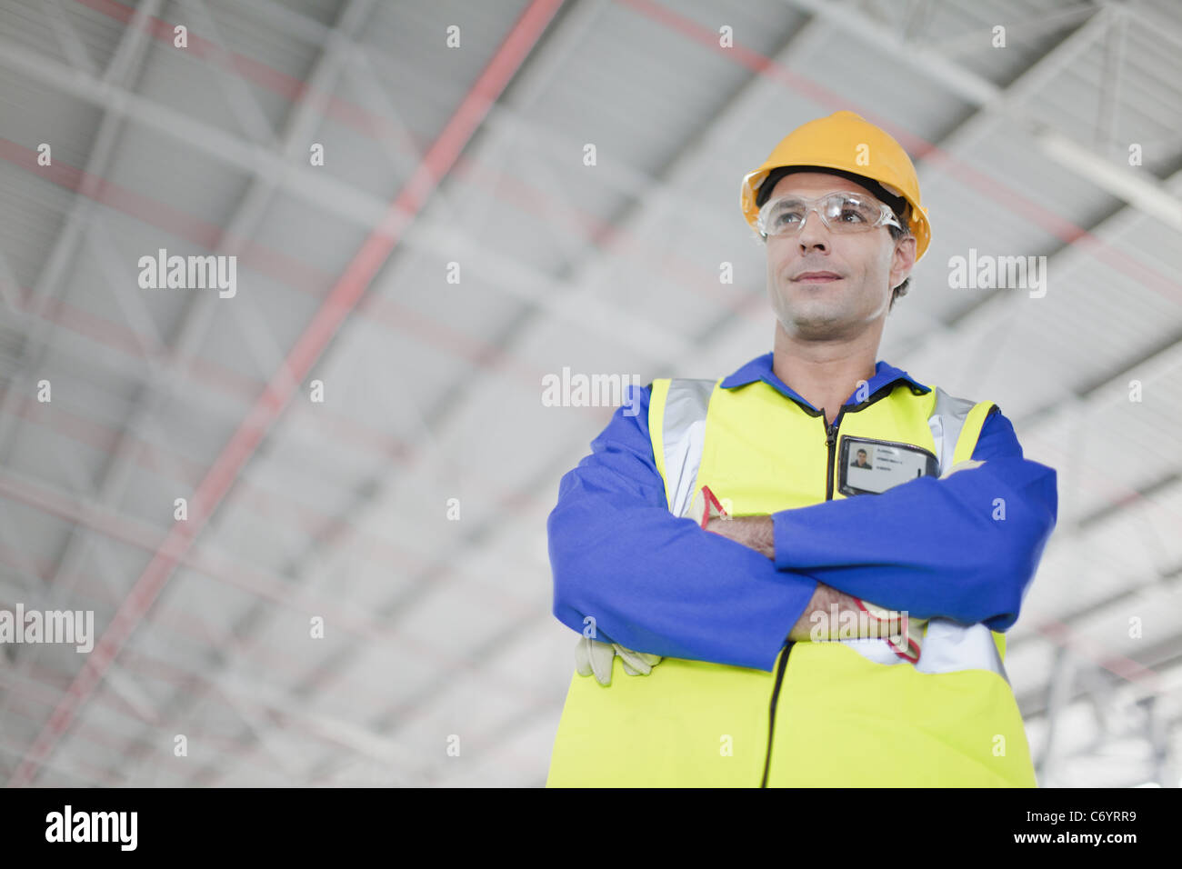 Worker standing in warehouse Stock Photo - Alamy