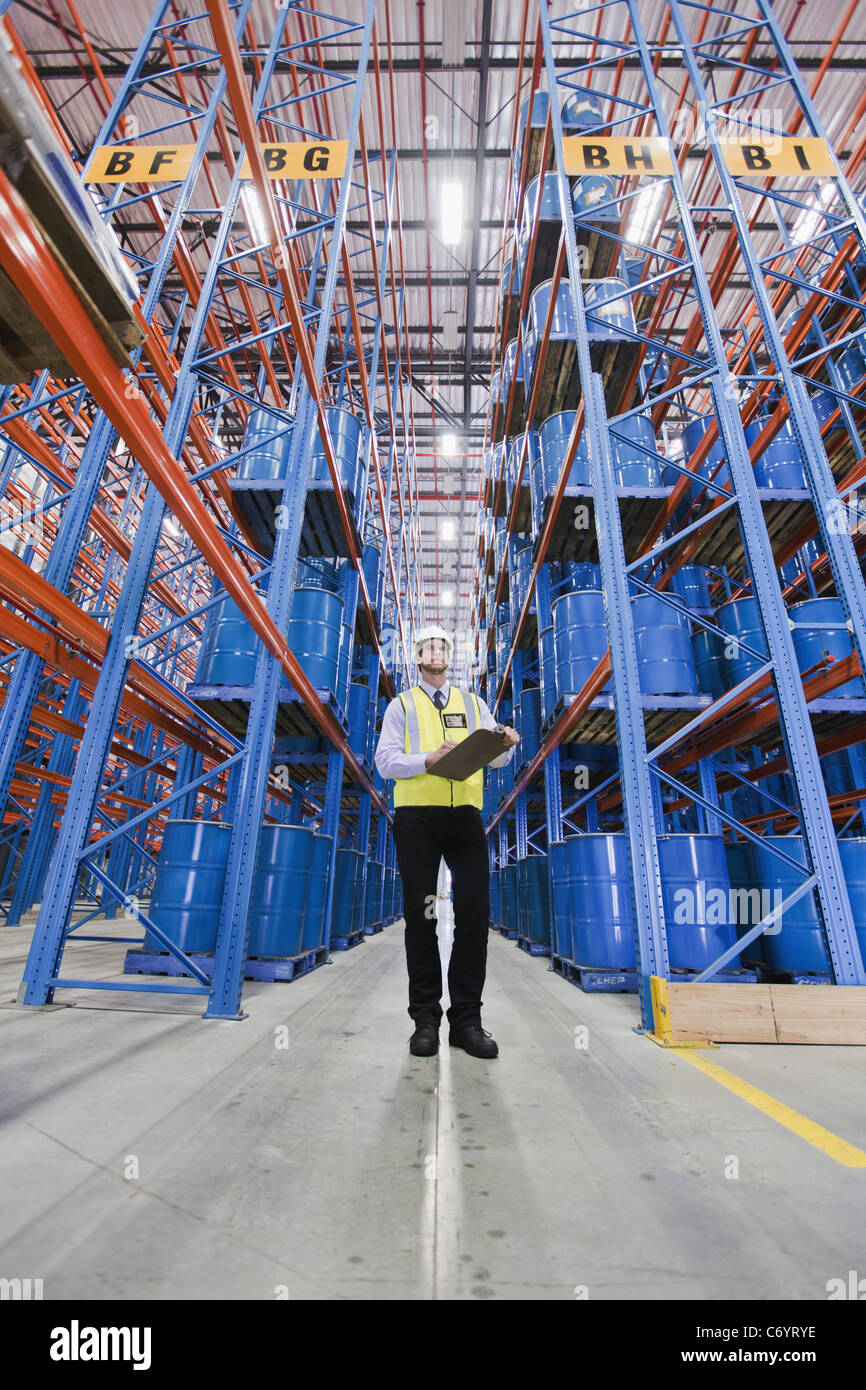 Worker standing in warehouse Stock Photo - Alamy