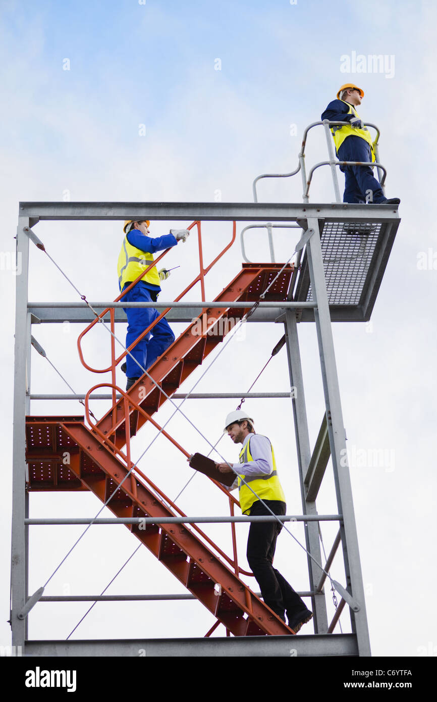 Workers climbing stairs on site Stock Photo - Alamy