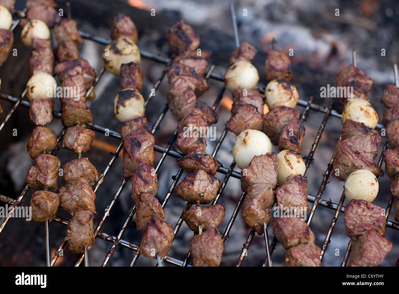 Beef shish kebab skewers cooking over a hot camp fire Stock Photo - Alamy