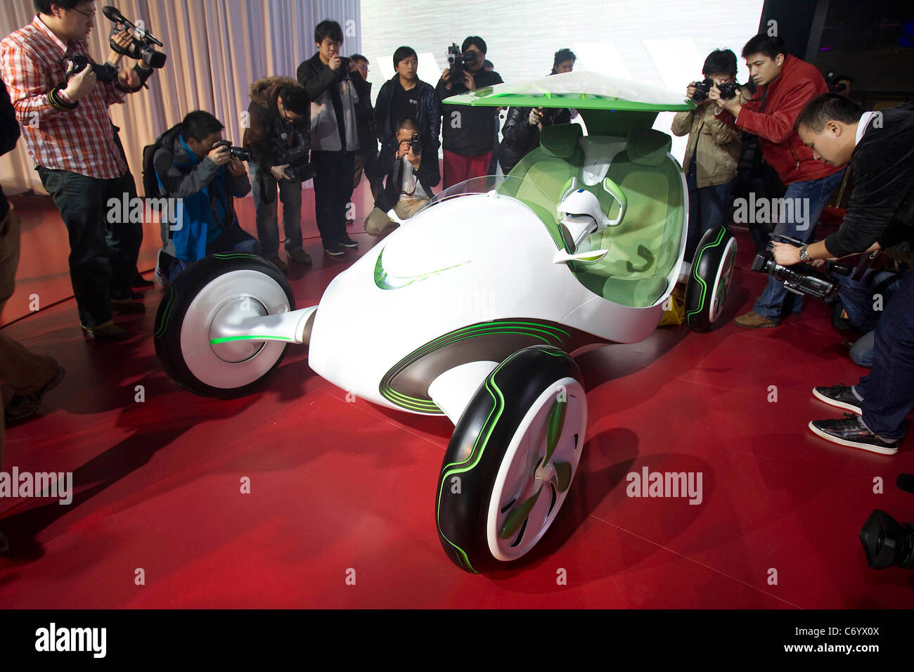 People look at a solar-power concept car named Leaf developed by SAIC ...