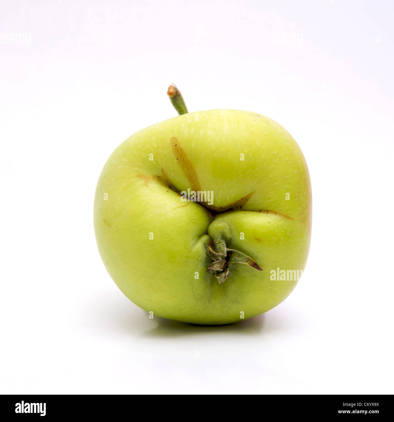 Fresh green apple with a unique shape isolated on white background ...