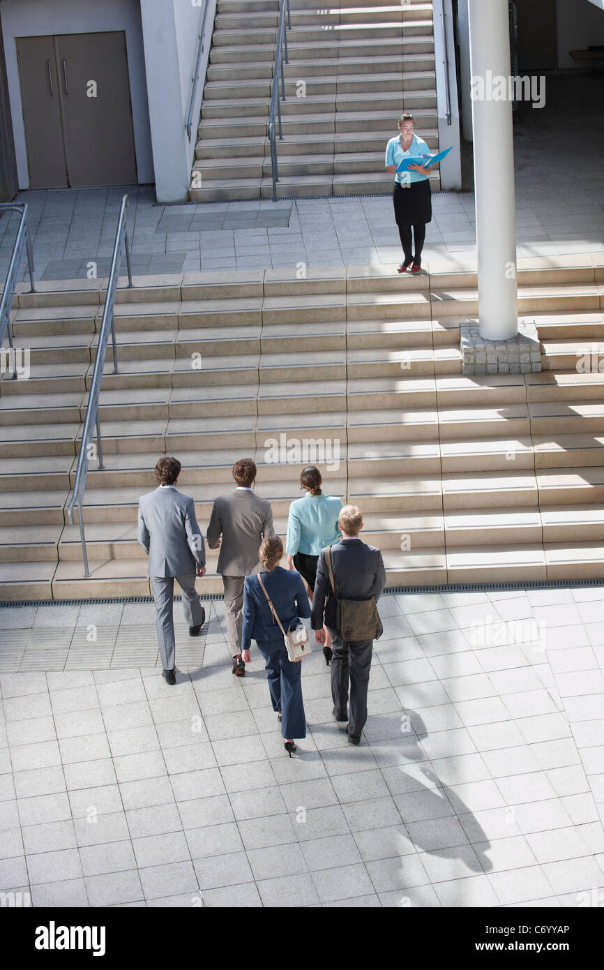 Business people walking on steps Stock Photo - Alamy