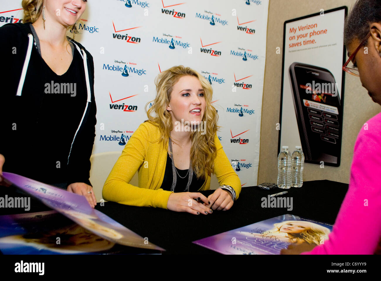 Emily Osment signs autographs whilst appearing on Verizon's Experience ...