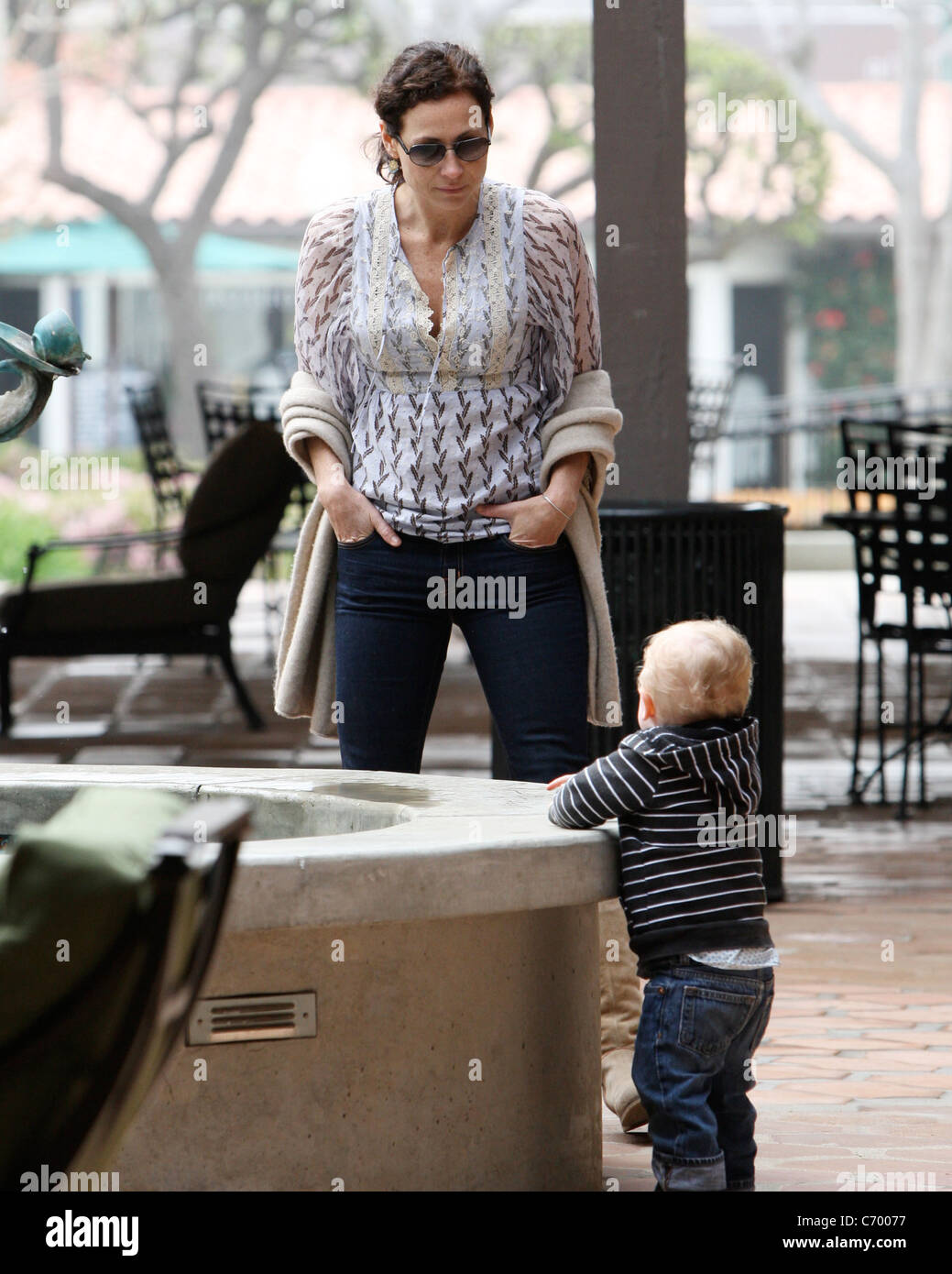 Minnie Driver and Henry Driver throwing coins into a wishing well at ...