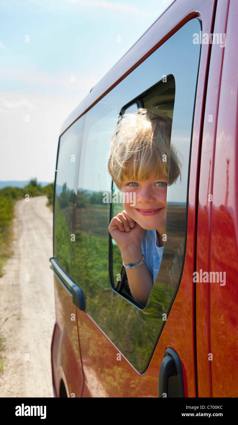 Boy peering out car window Stock Photo - Alamy
