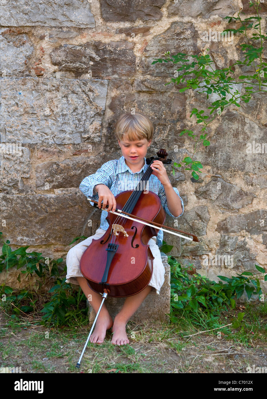 Boy playing cello outdoors Stock Photo - Alamy