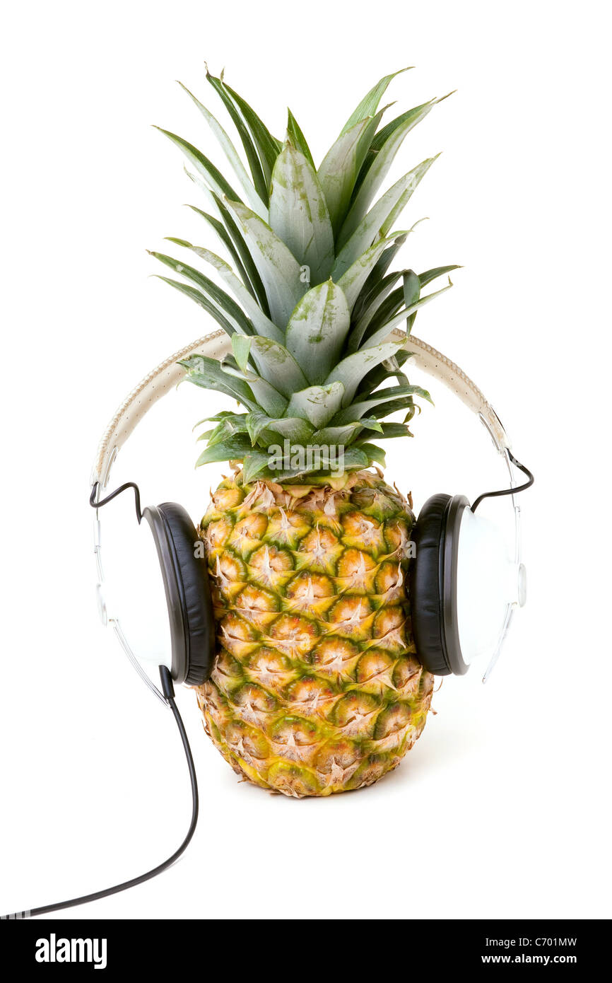 A fresh ripe pineapple wearing headphones isolated over a white ...