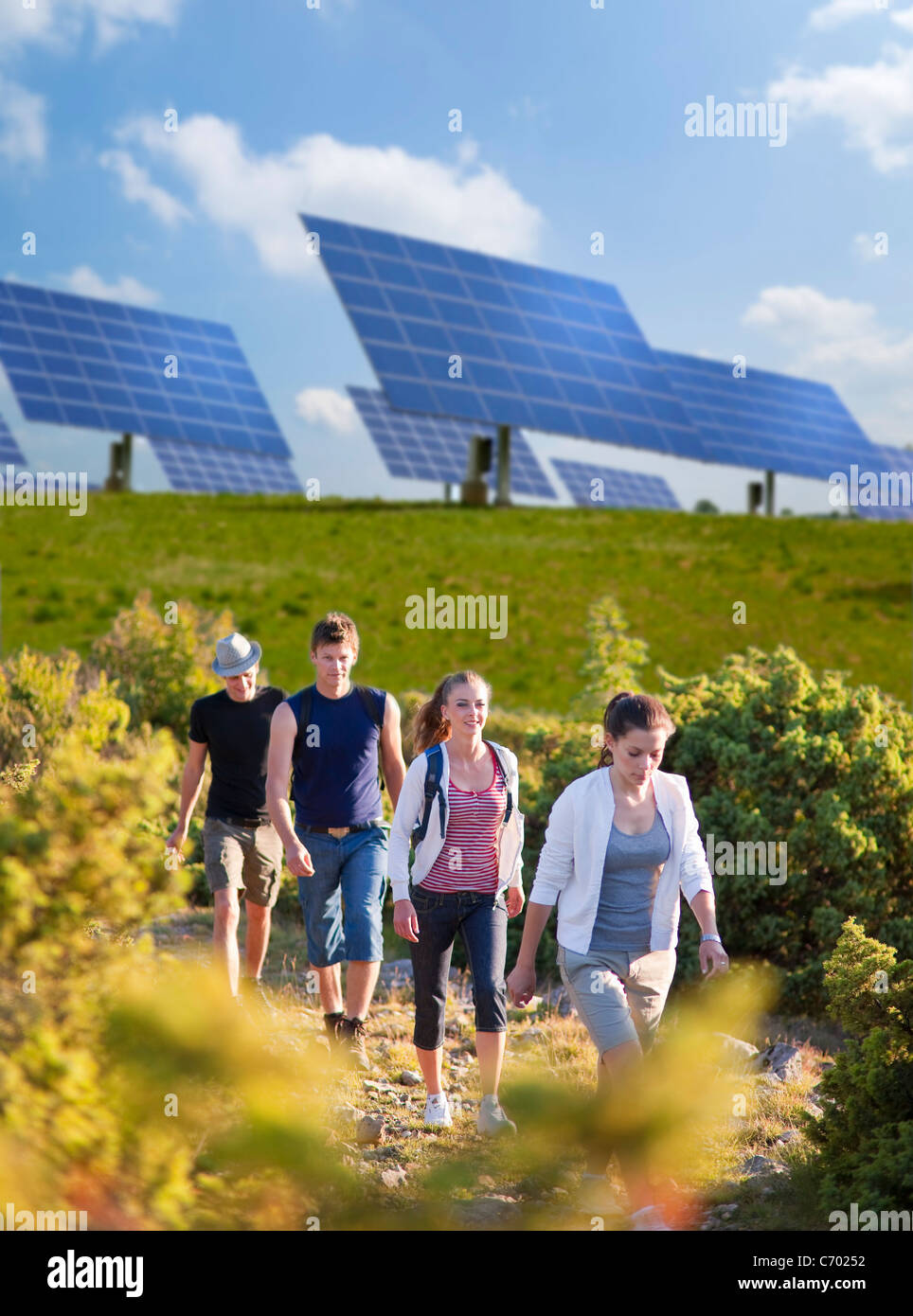 People walking by solar panels Stock Photo - Alamy