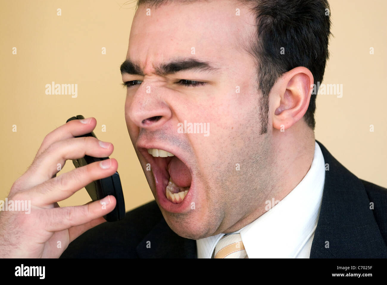 A business man is furiously screaming into his cell phone Stock Photo ...
