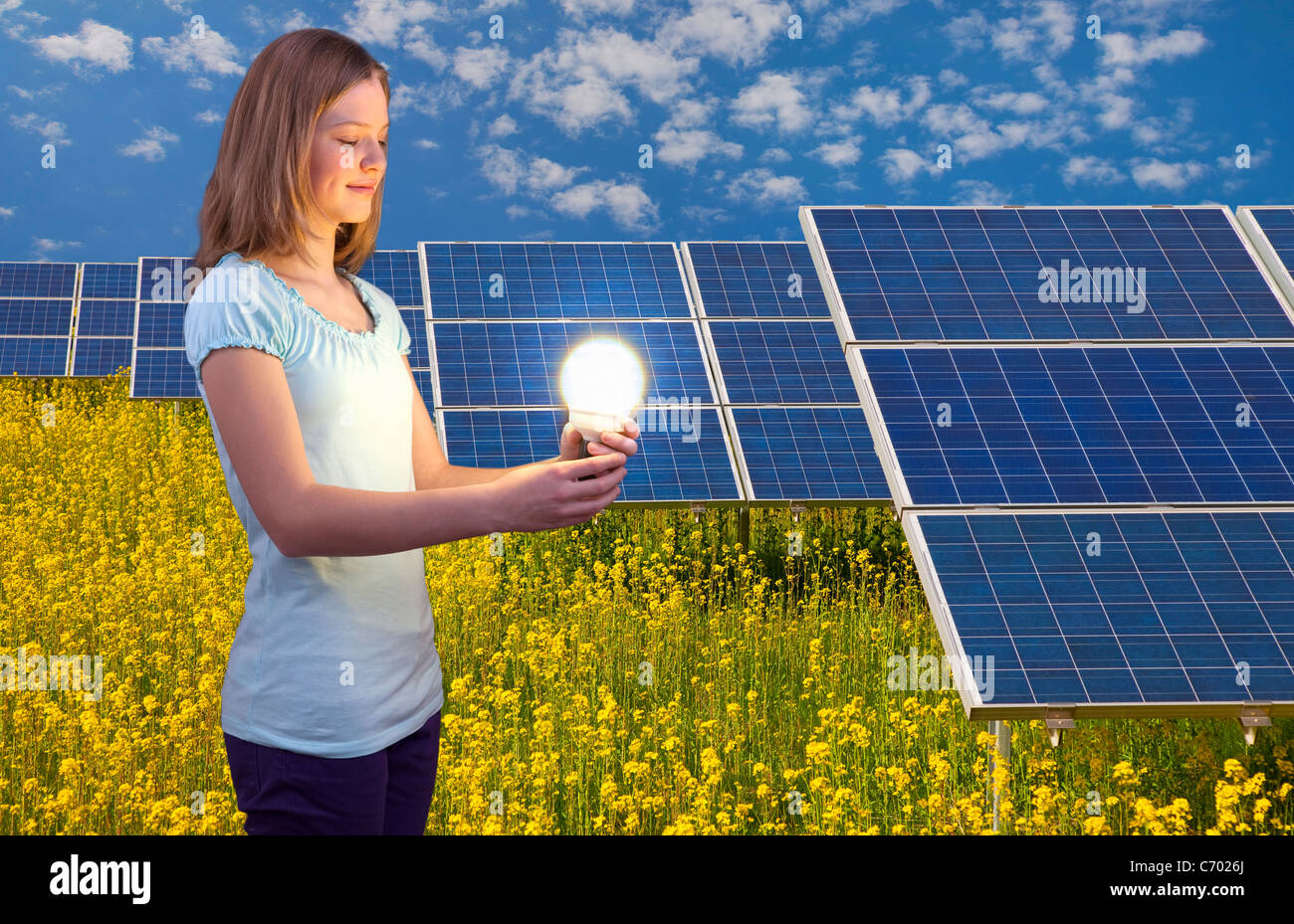 Woman with lightbulb and solar panels Stock Photo - Alamy