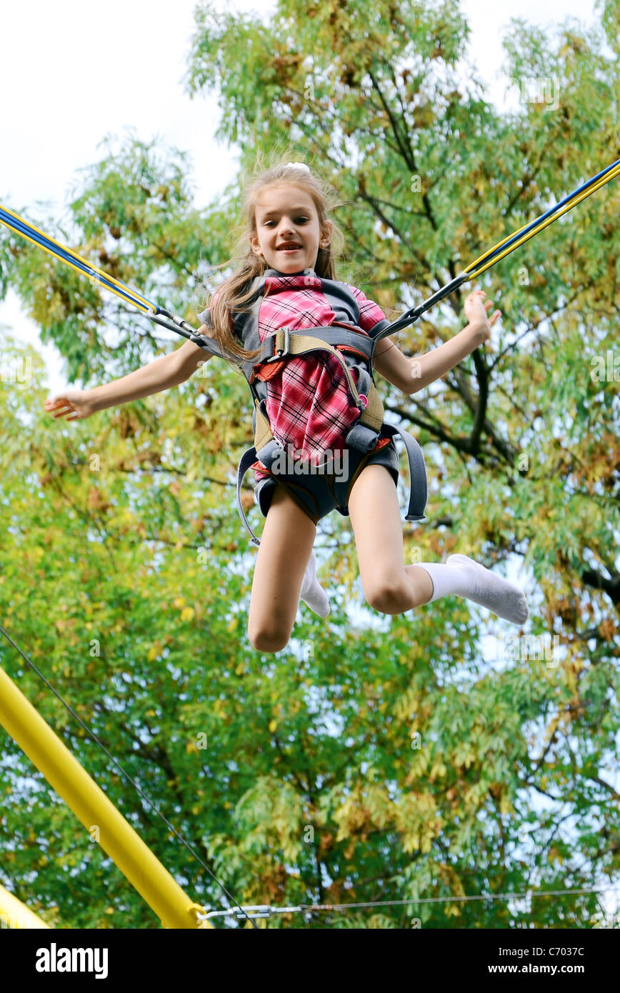 a girl jumping on elastic bands Stock Photo - Alamy