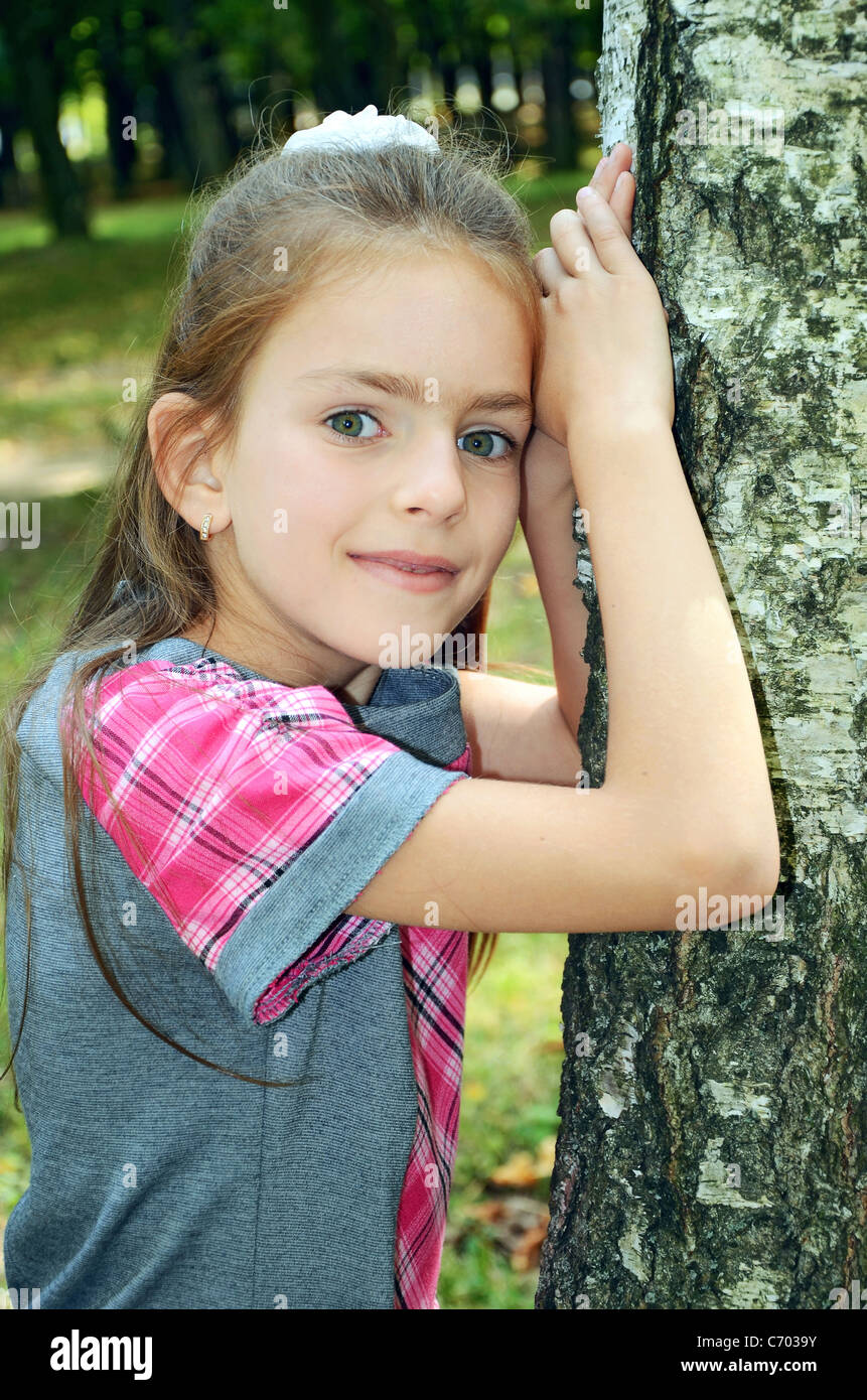 girl standing near a tree Stock Photo - Alamy