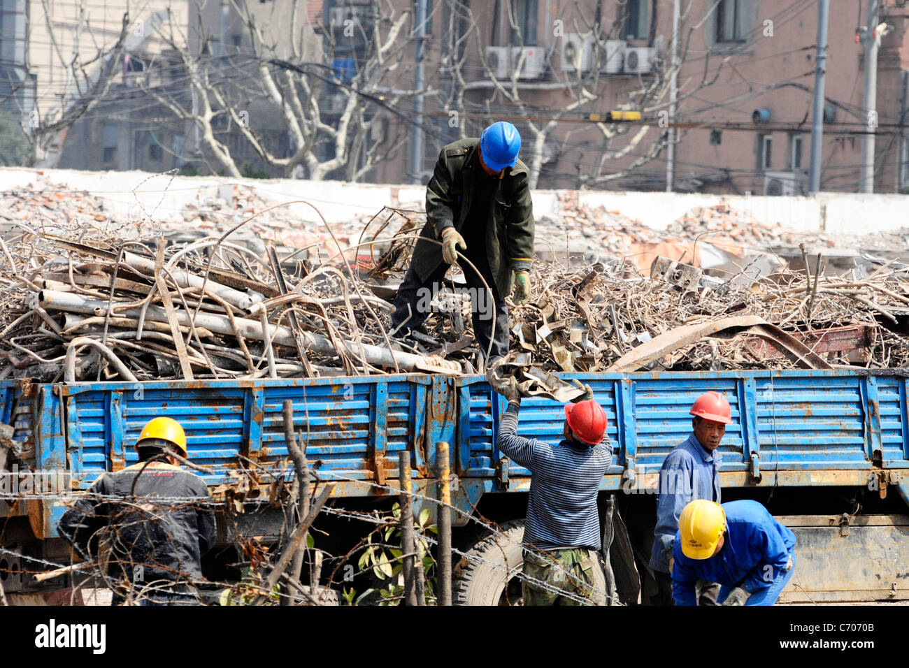 Chinese workers clearing up after the demolition of part of old ...
