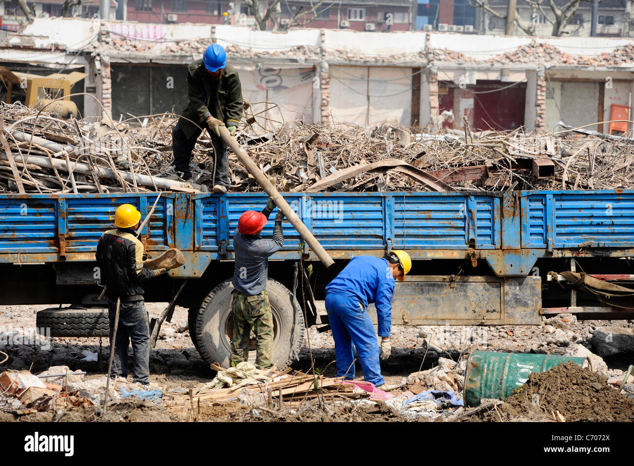 Chinese workers clearing up after the demolition of part of old ...