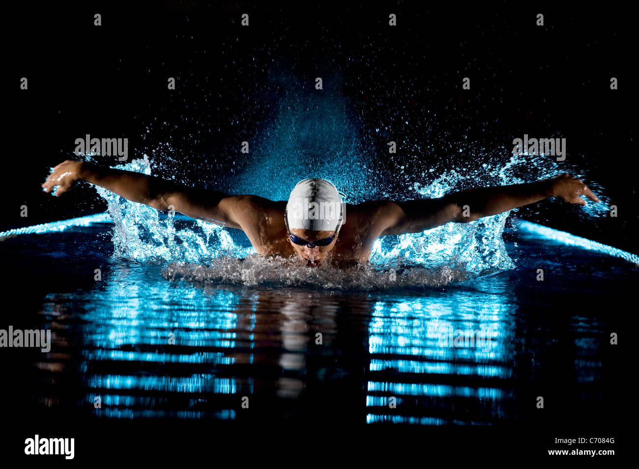 Taking breath swimming butterfly isolated black background Stock Photo ...