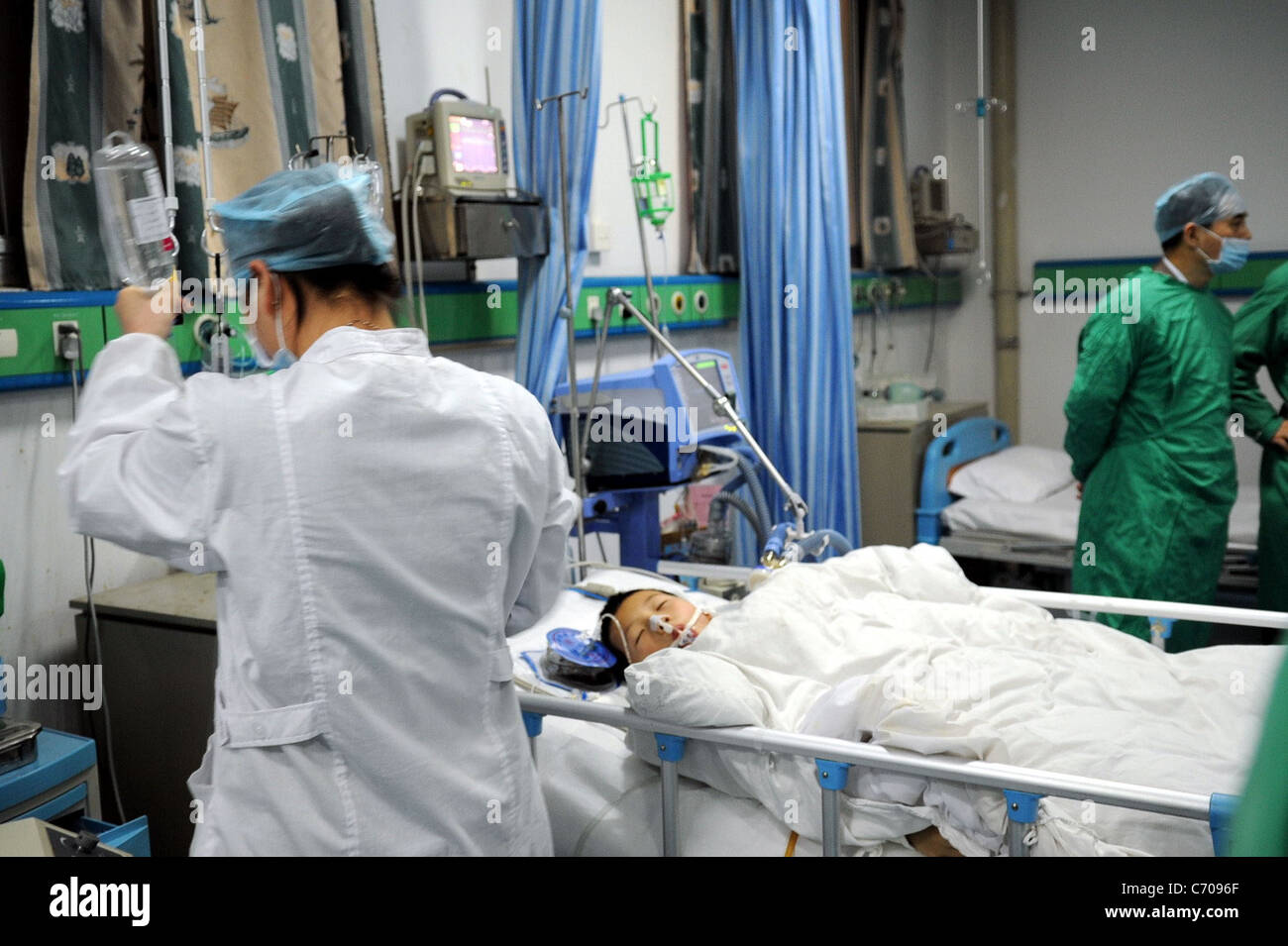 An injured child gets treatment at a hospital in Nanping in southeast ...