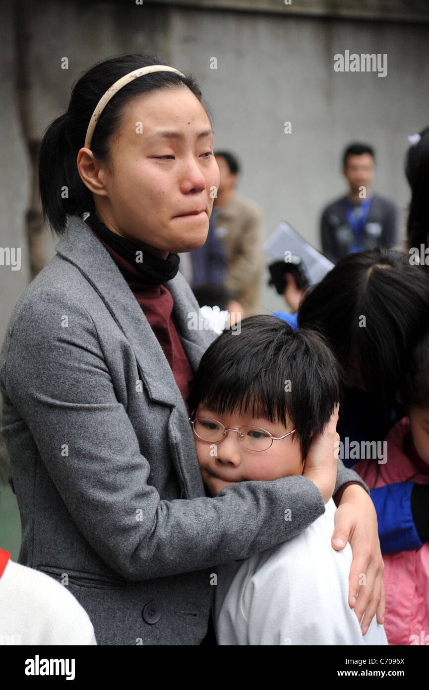 A grieving teacher holds a student after a memorial service for the ...