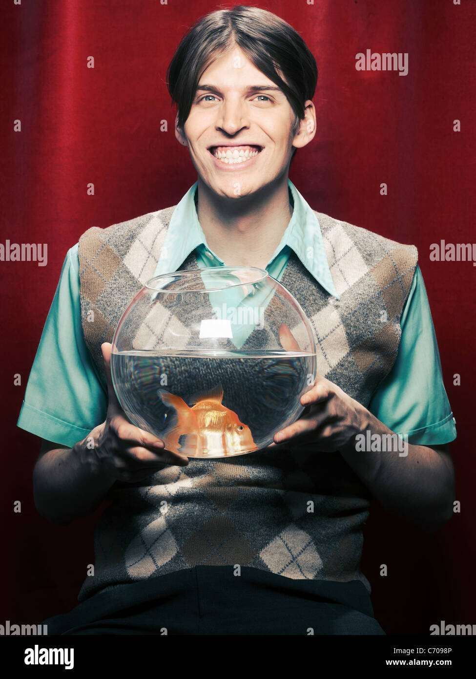 Smiling man holding fishbowl hi-res stock photography and images - Alamy