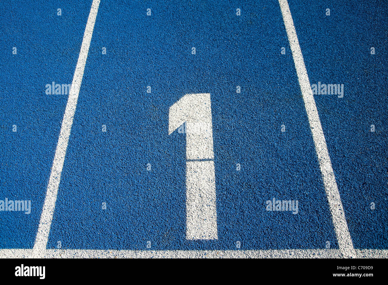 Number 1 on a blue running track Stock Photo - Alamy